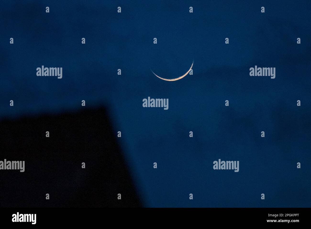 The crescent moon or Ramadan moon rises over the sky on the first day ...