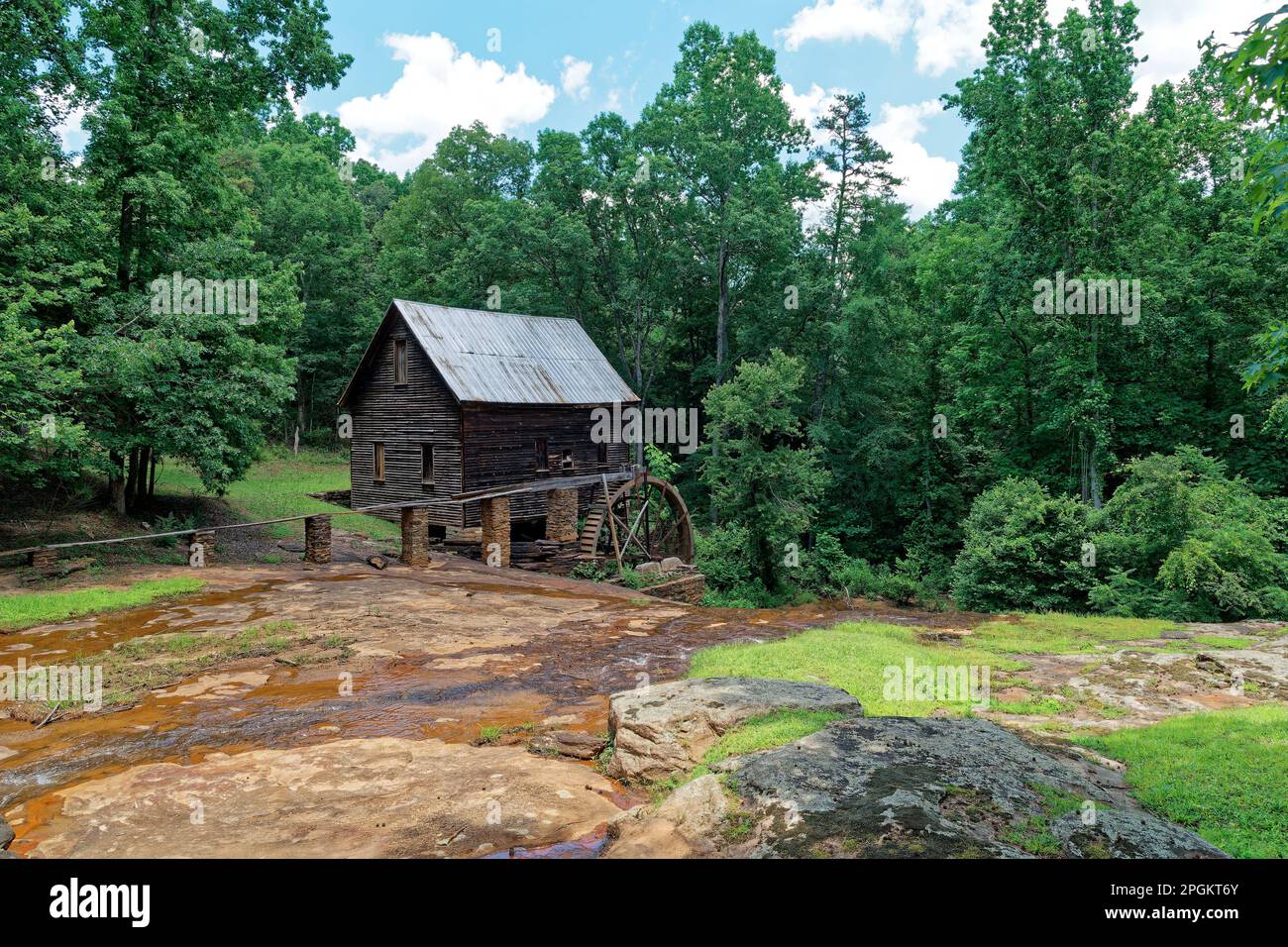 Full landscape setting of the Ragsdale mill with waterwheel a restored ...
