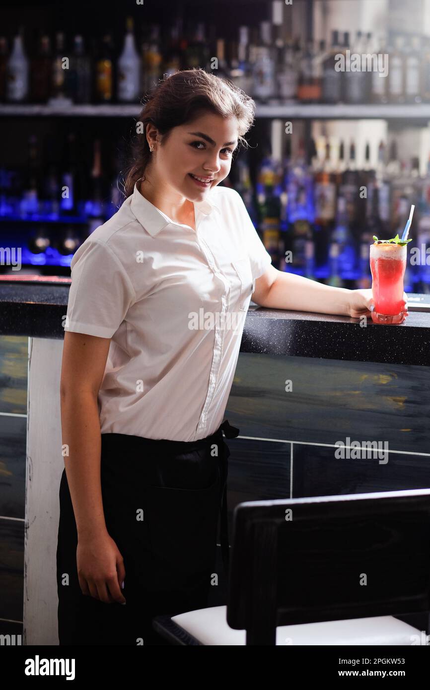 waitress holding drink professional bar service Stock Photo - Alamy
