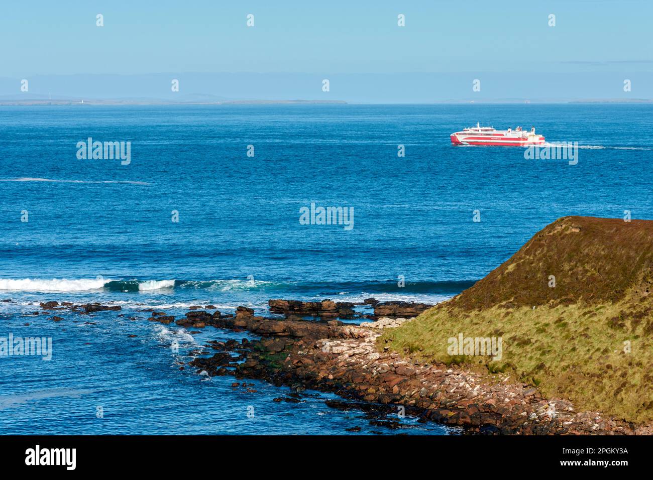 The Gills Bay to Orkney ferry, the MV Alfred, passing by the eastern ...