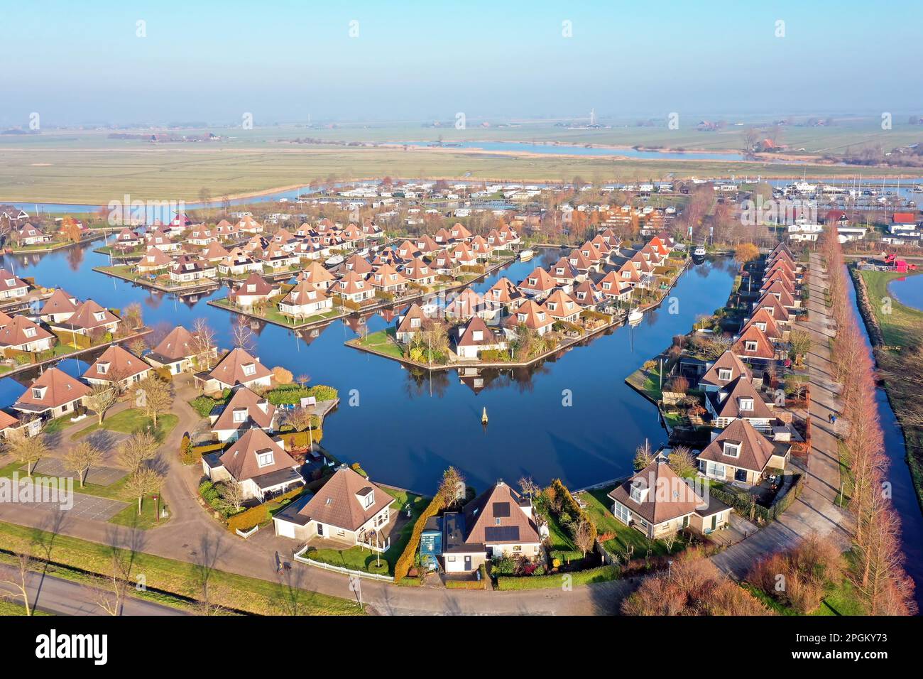 Aerial from a typical dutch landscape: houses and water in Friesland ...