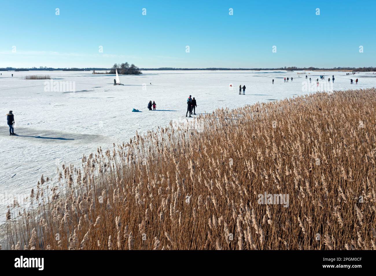 Aerial from ice sailing and skating on Bergumer lake in winter in ...