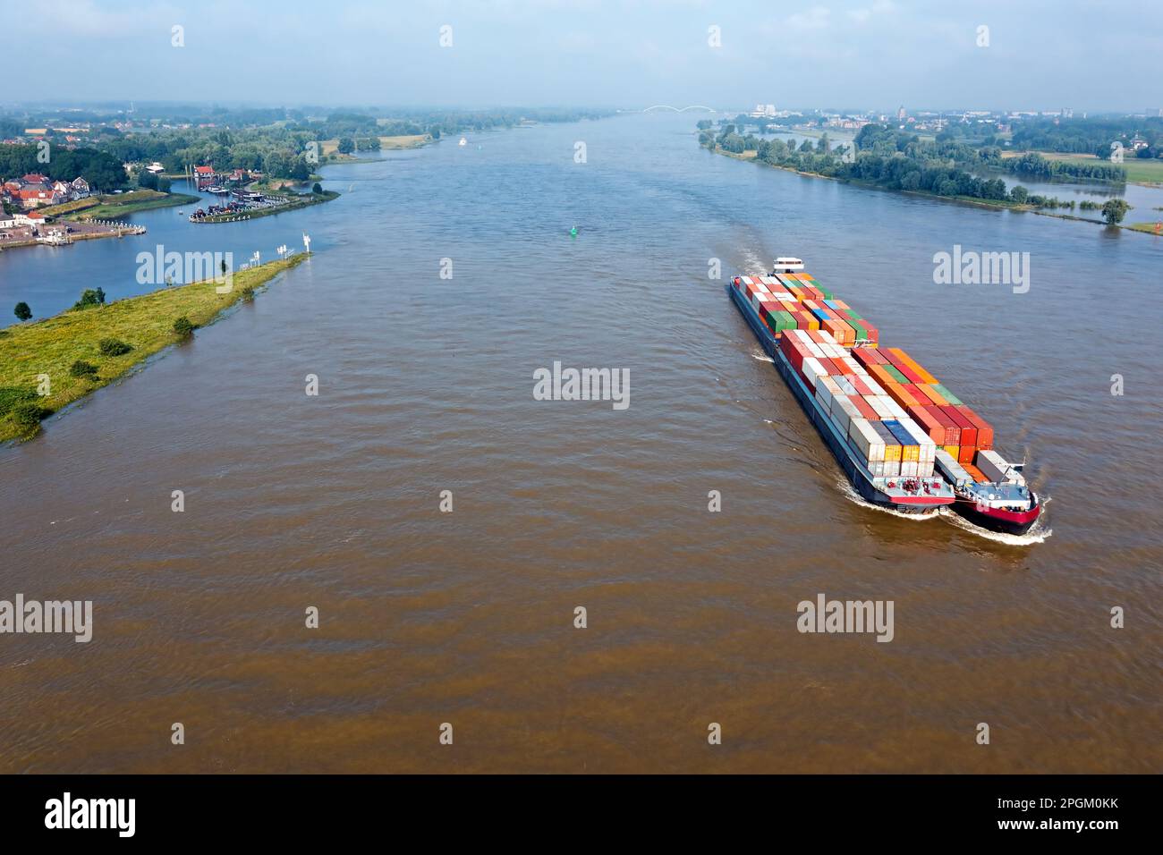 Aerial from a freighter full of containers cruising on the river ...