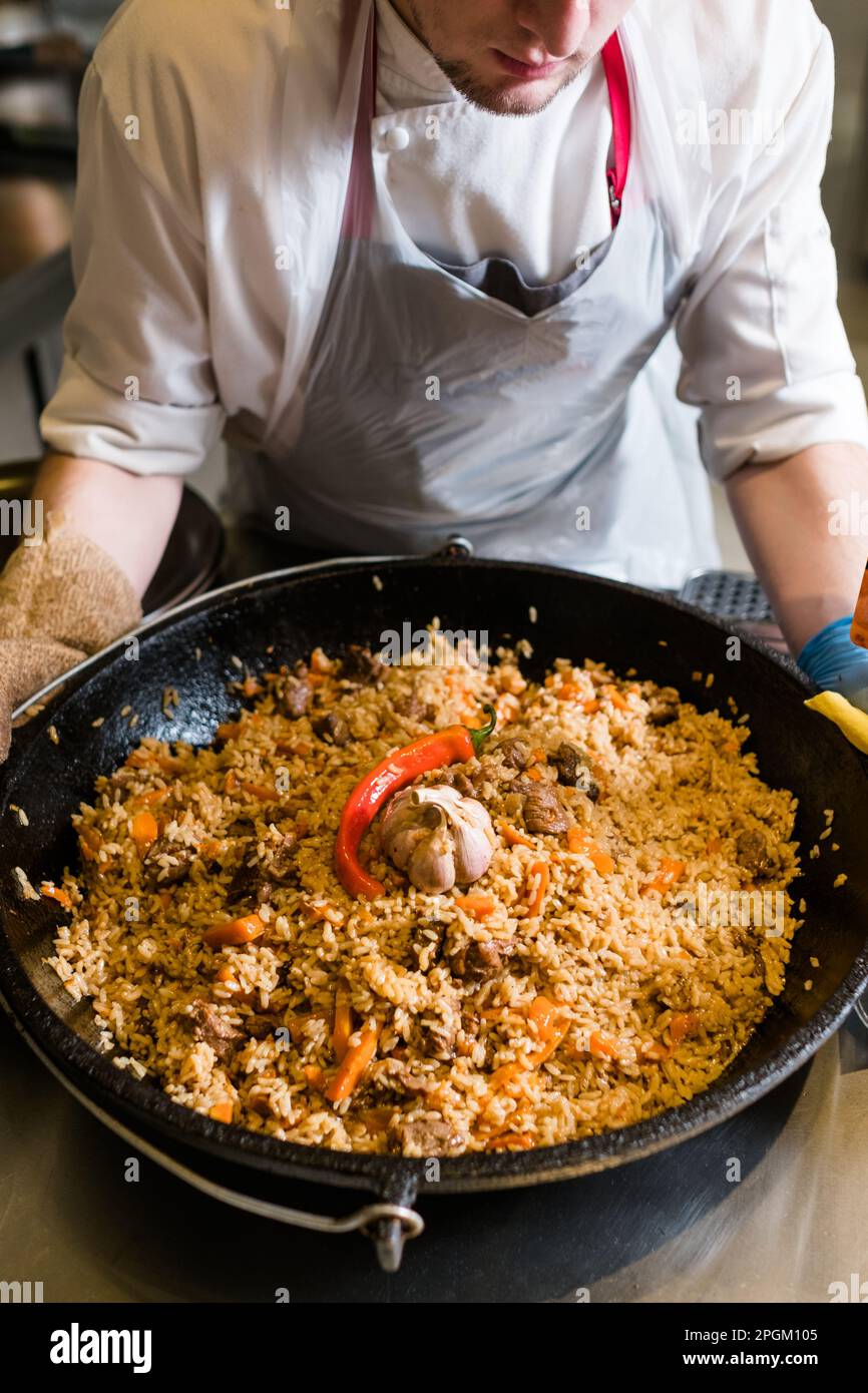 chef cooking plov traditional uzbek rice meal Stock Photo - Alamy