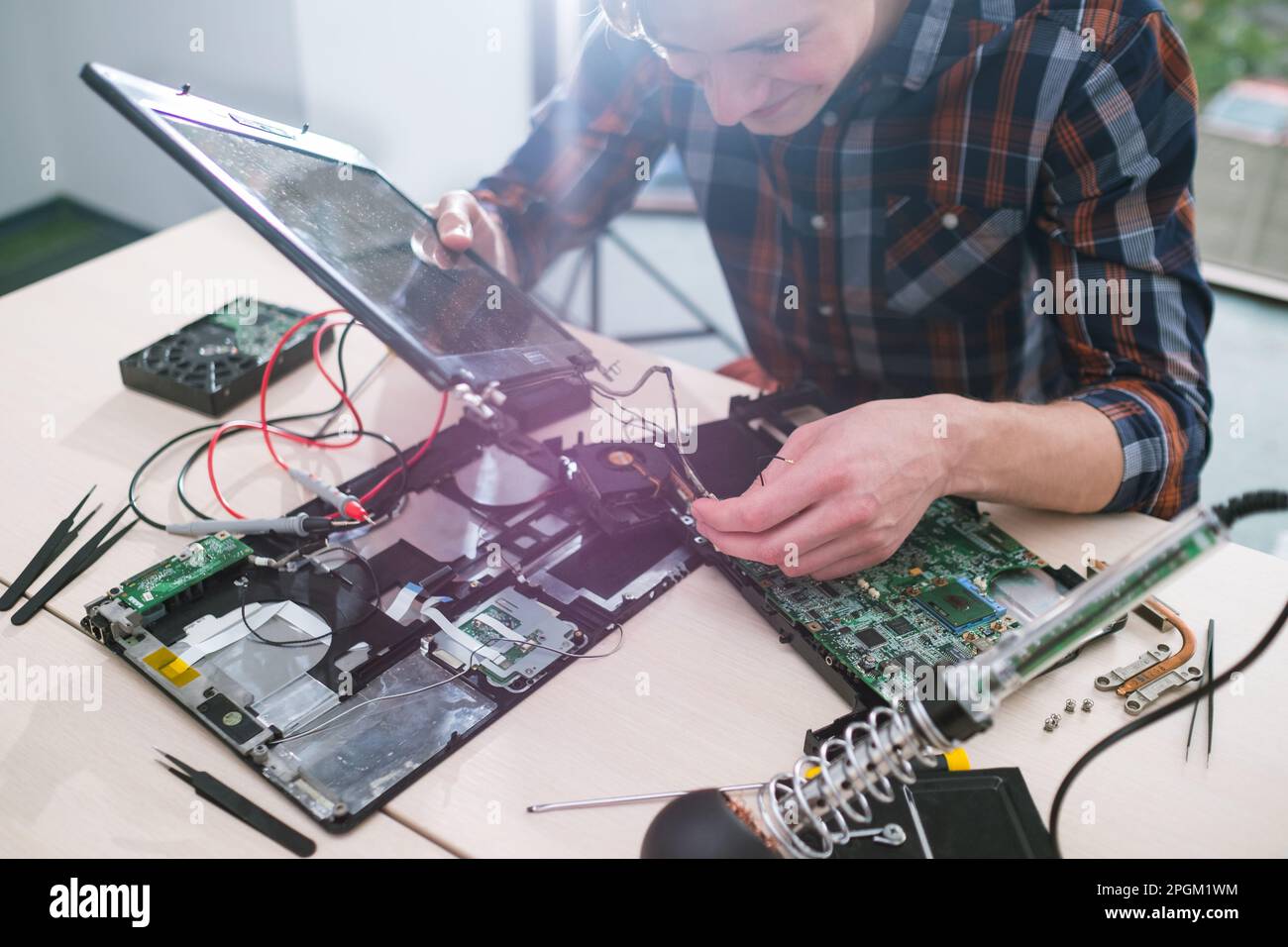 Electronics repairman fixing broken hi-res stock photography and images ...