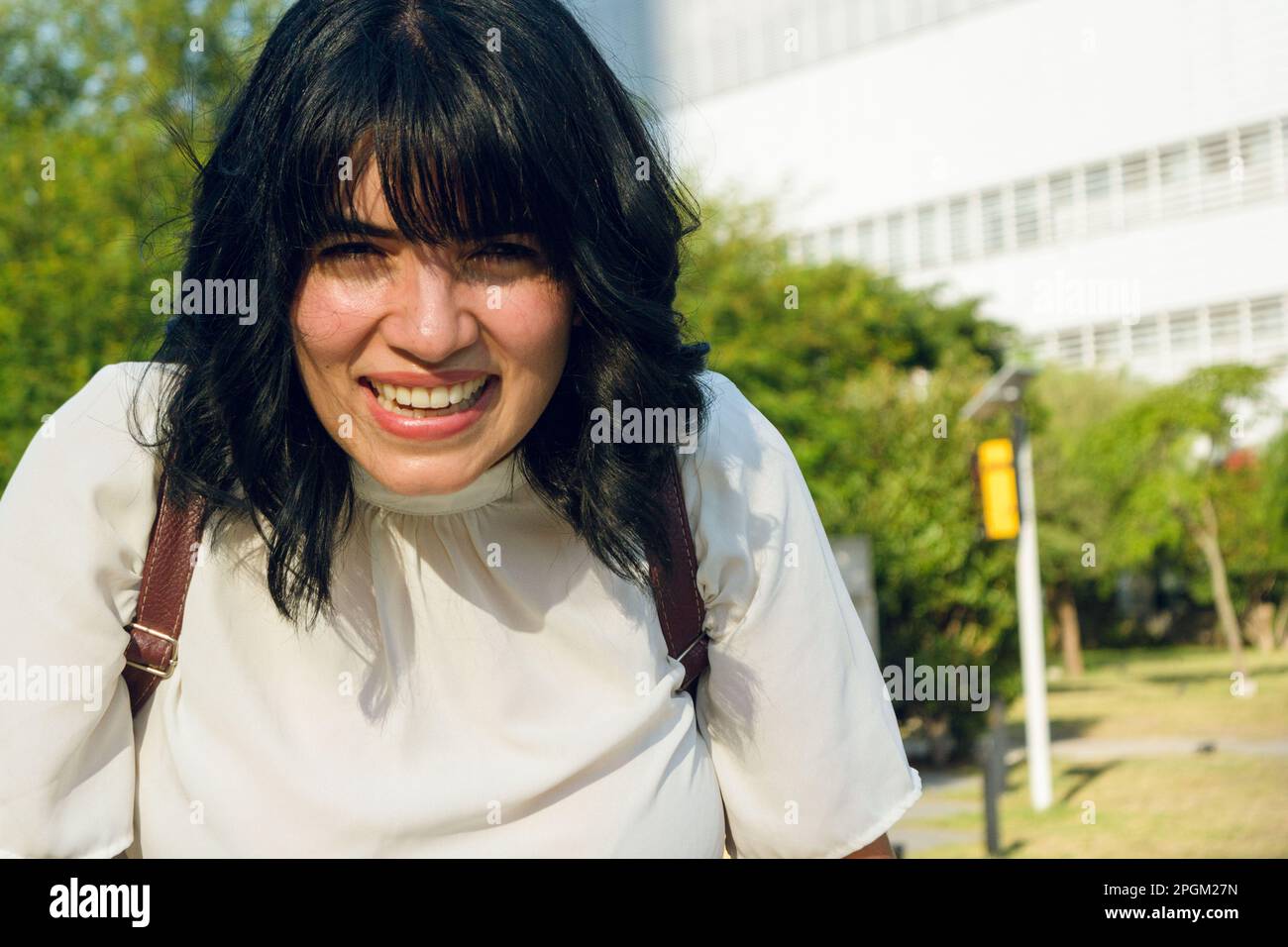very happy young venezuelan woman outdoors, laughing looking at the ...