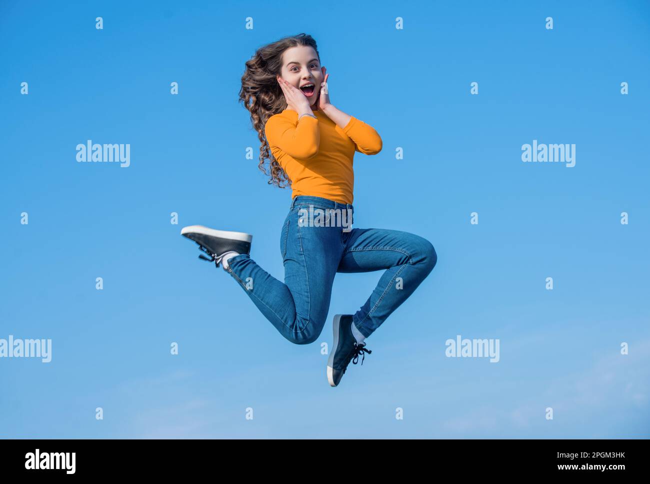 glad teen girl jump high on sky background Stock Photo - Alamy