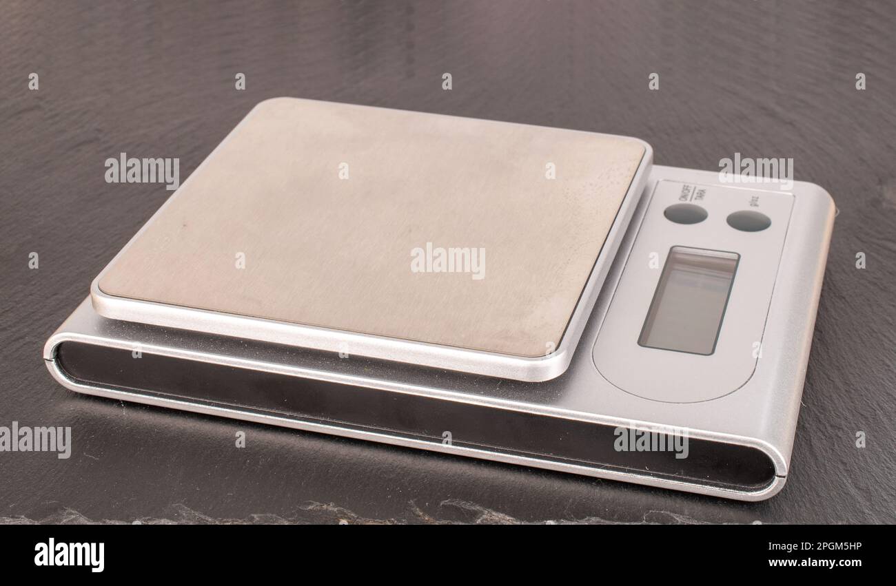 Kitchen scales on slate stone, macro Stock Photo - Alamy