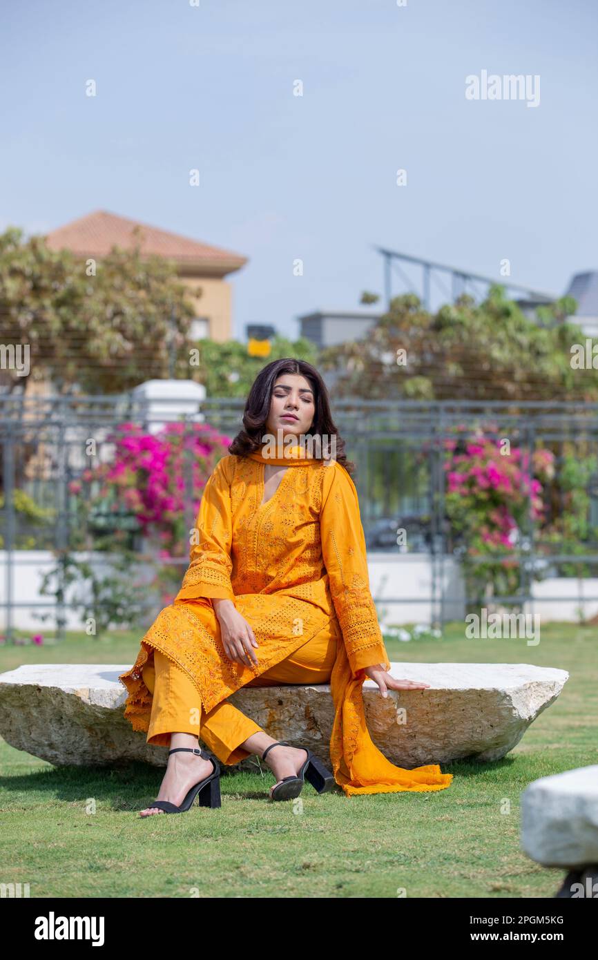 Female Model Posing Outdoors Wearing Orange Indian Pakistani Asian