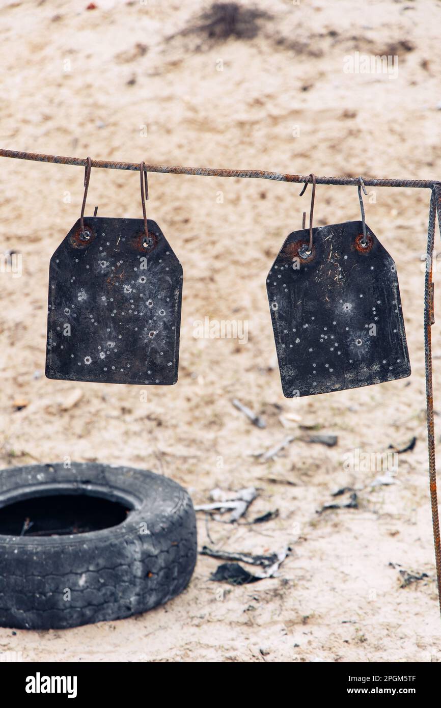 Two targets shot through by bullets from firearm are at a training ...
