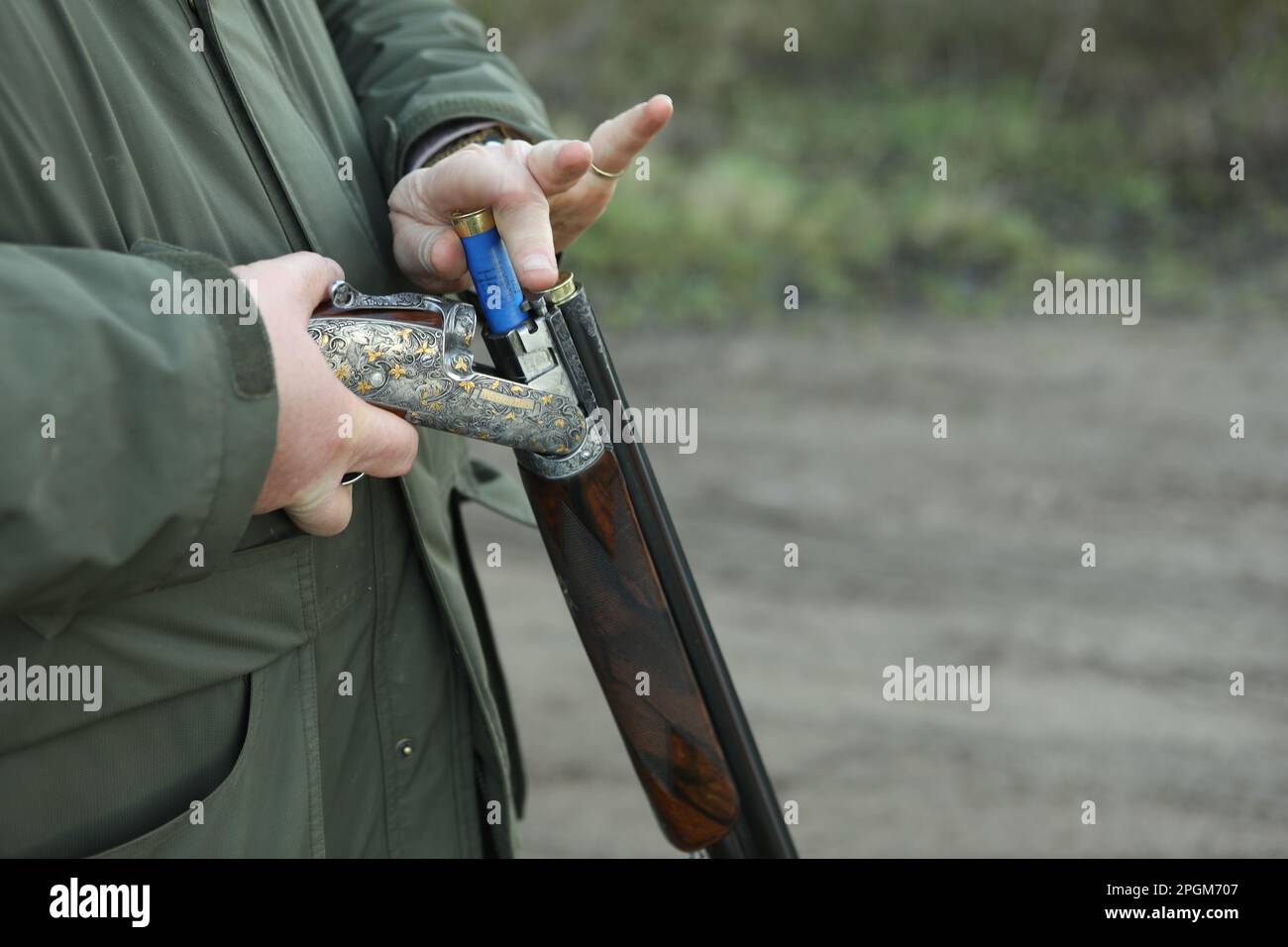 A close up of a man shooting game in the countryside Stock Photo - Alamy