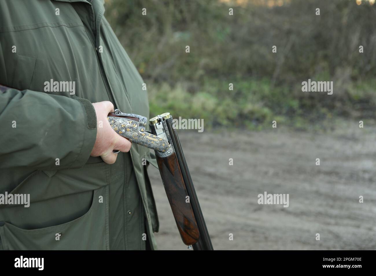 Man holding gun resting hi-res stock photography and images - Alamy