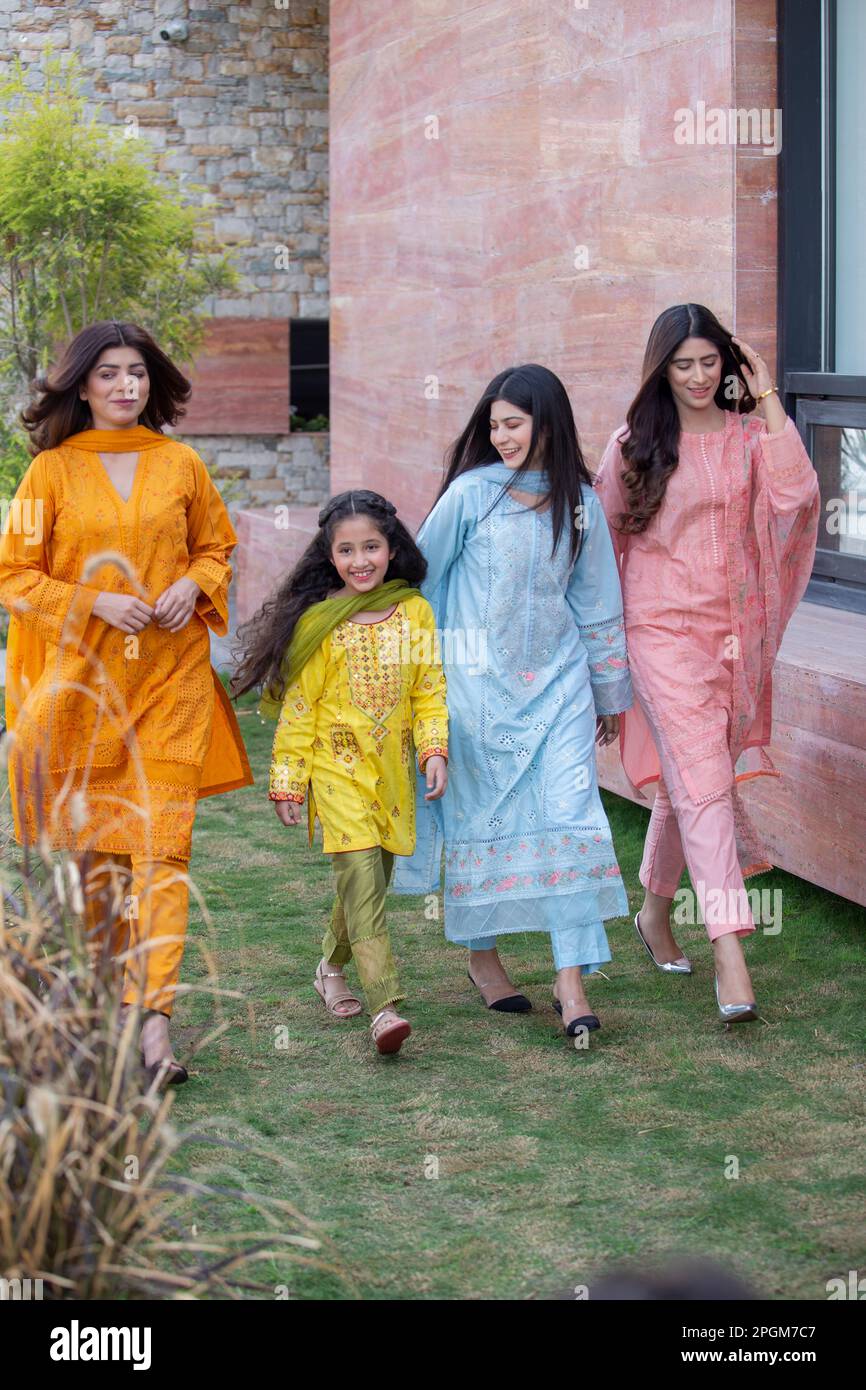 Female models posing outdoors wearing dresses Indian Pakistani Asian ...