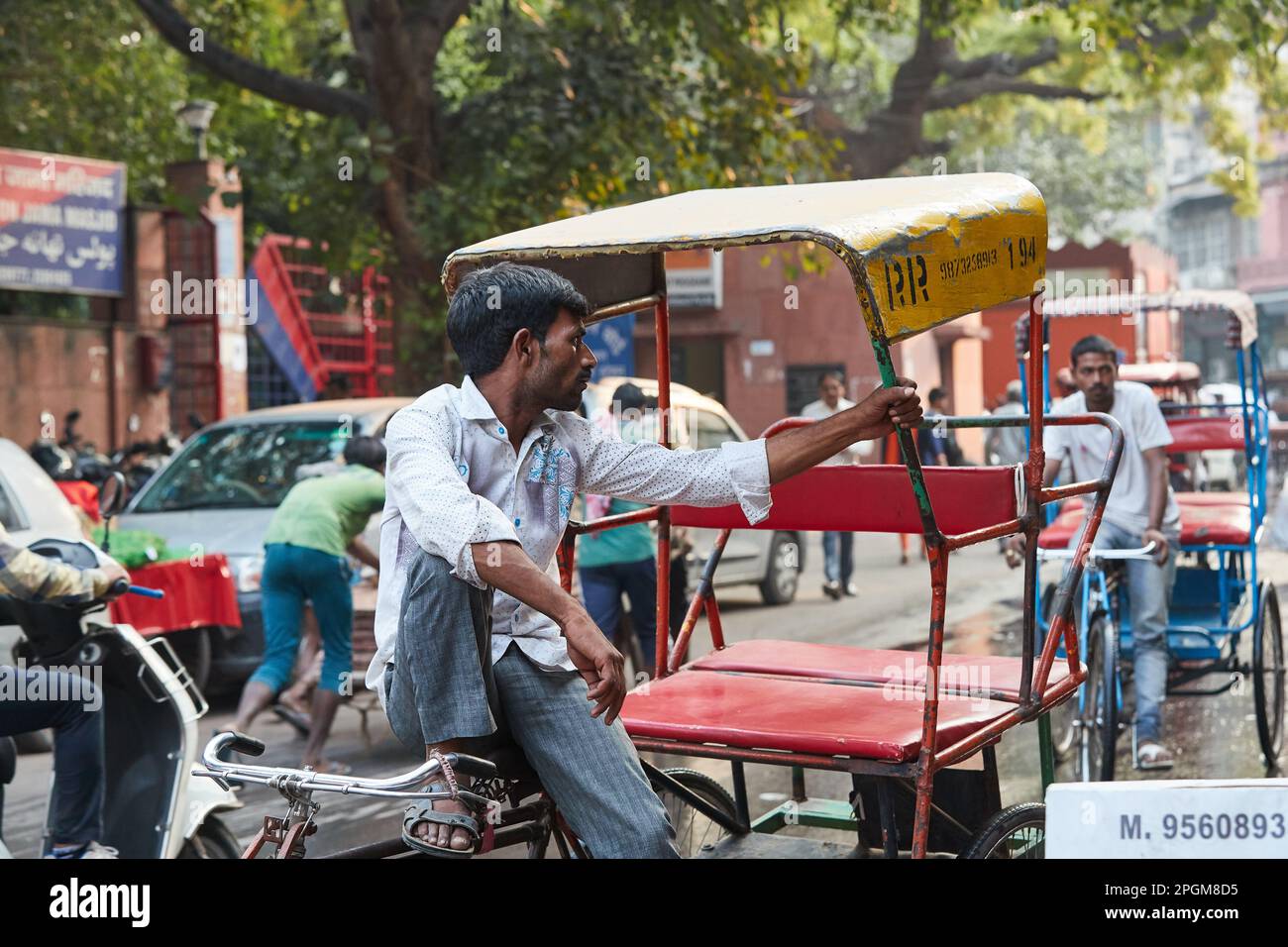 Delhi, India - male indian rikscha driver sitting on rikscha waiting ...