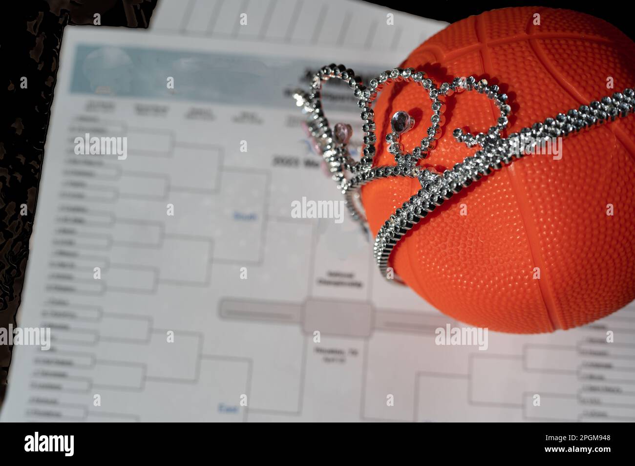 Basketball, tiara, and blank bracket signifying a Cinderella season ...