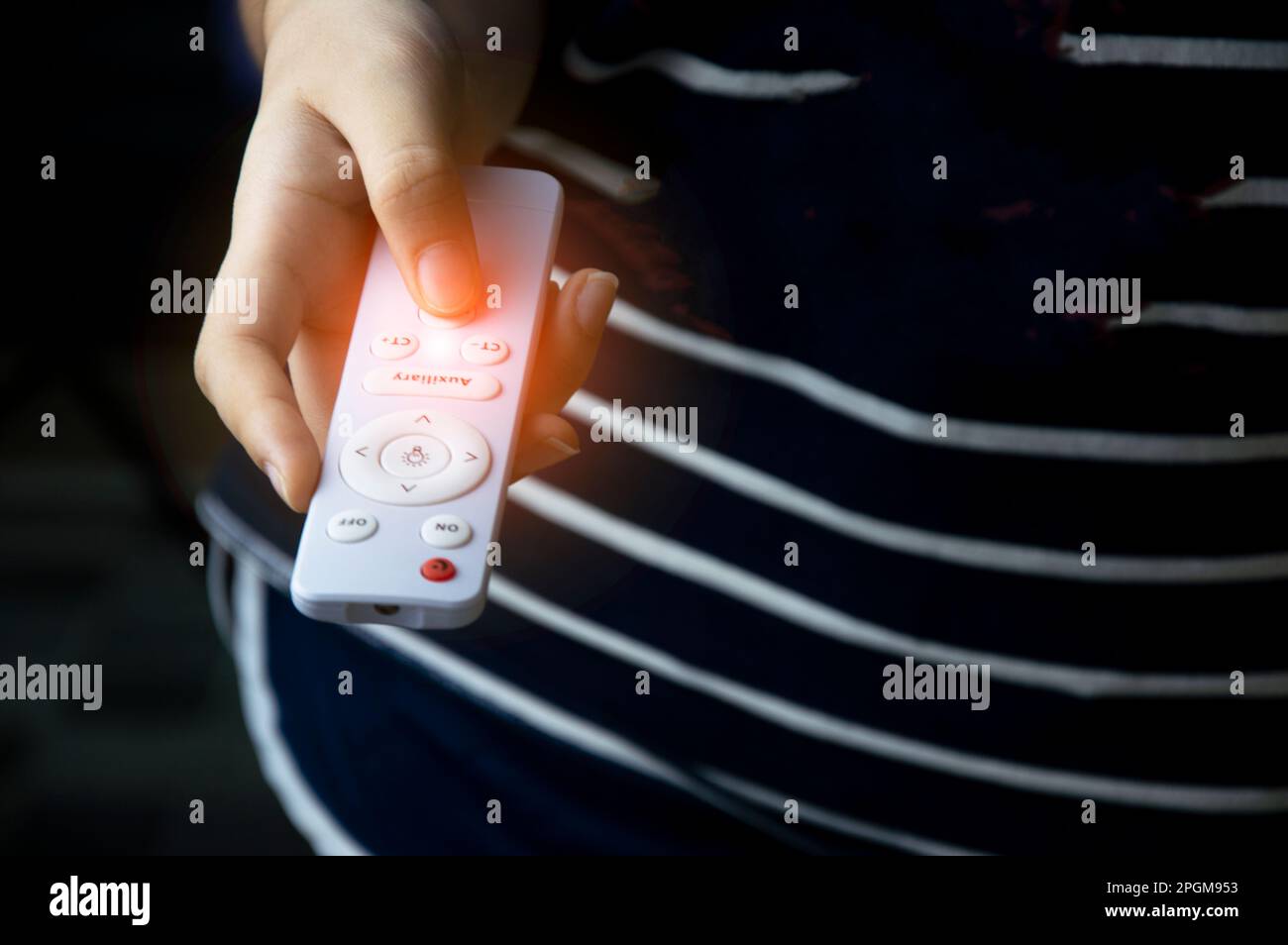 White tone remote control, woman using remote control Stock Photo - Alamy