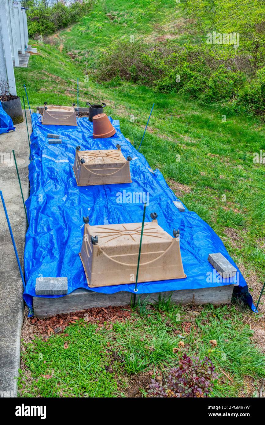 Vertical shot of a small apartment raised garden covered with a tarp to ...