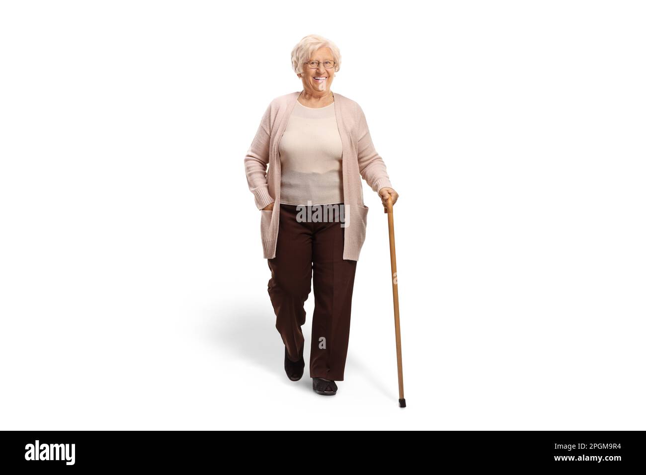 Full length portrait of a senior woman with a cane walking towards ...