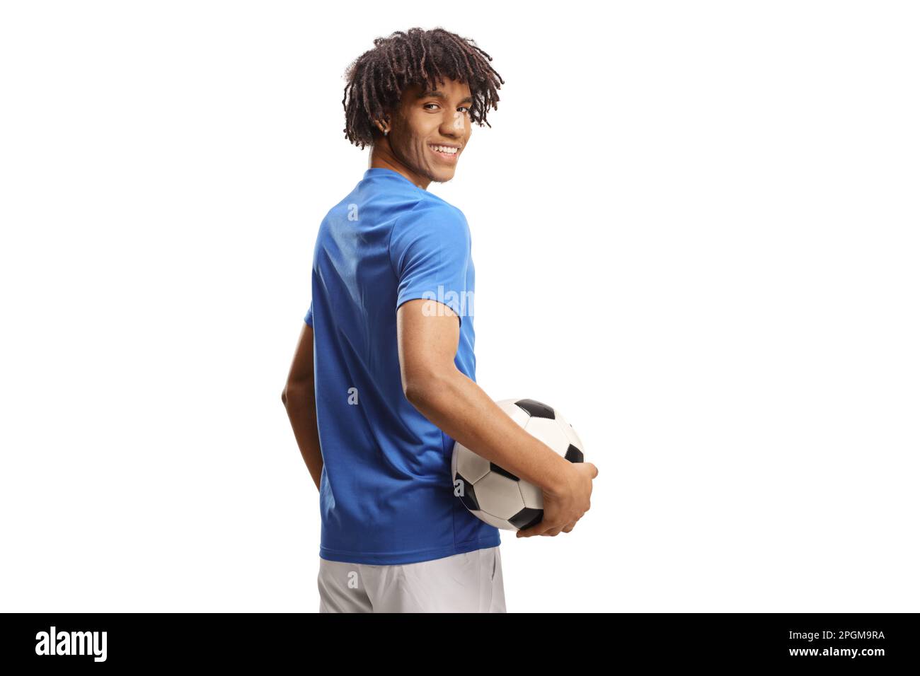 African american football player holding a ball and looking behind ...