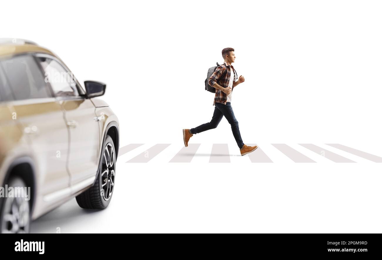 Full length profile shot of a male student running at a pedestrian ...
