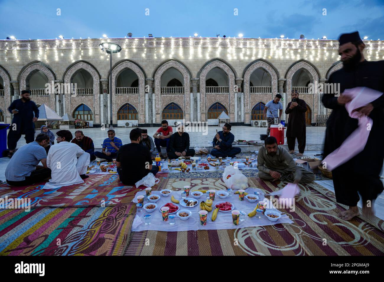 Muslims gather for a free public Iftar meal during the first day of ...
