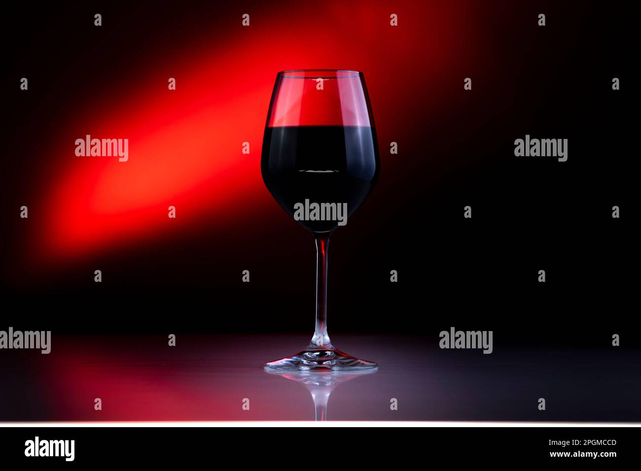 glass of red wine in a red background and red light Stock Photo - Alamy