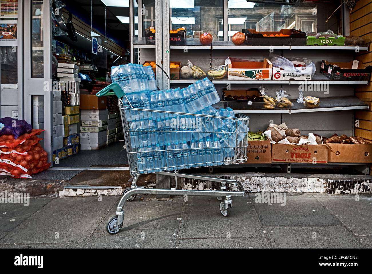 Supermarket trolley piled high with bottled water hi-res stock ...