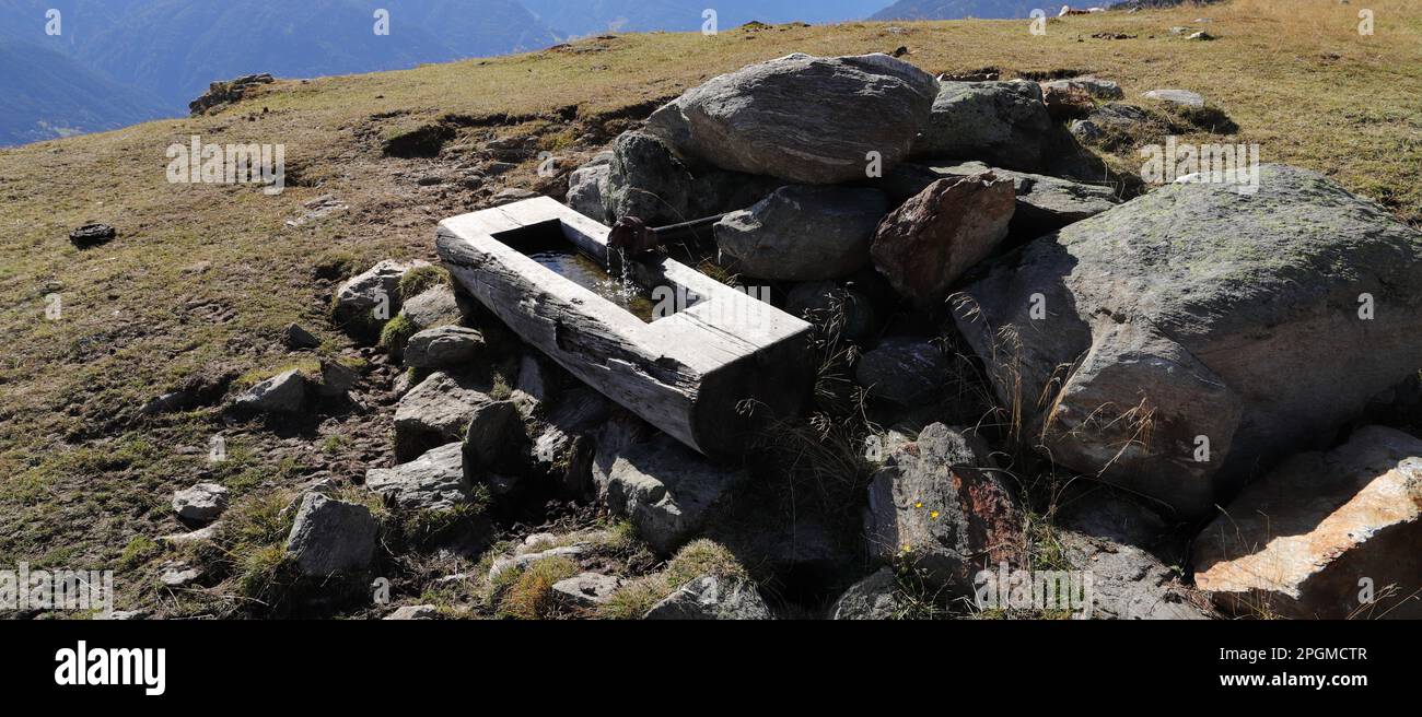Wooden water trough in the mountains hi-res stock photography and ...