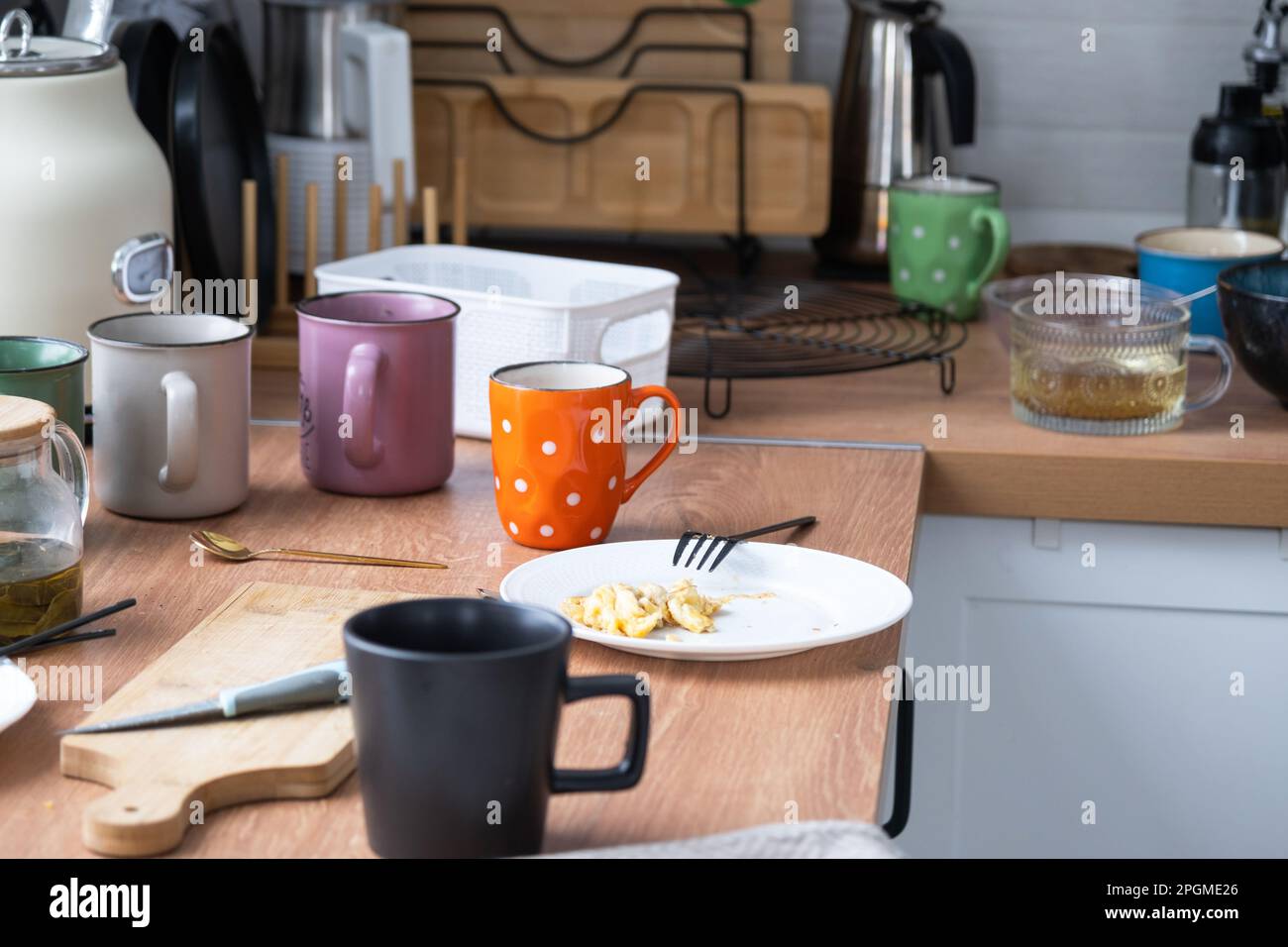 A mess in the kitchen, dirty dishes on the table, scattered things ...