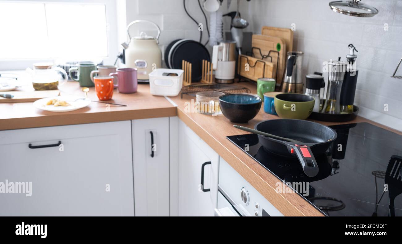 A mess in the kitchen, dirty dishes on the table, scattered things ...