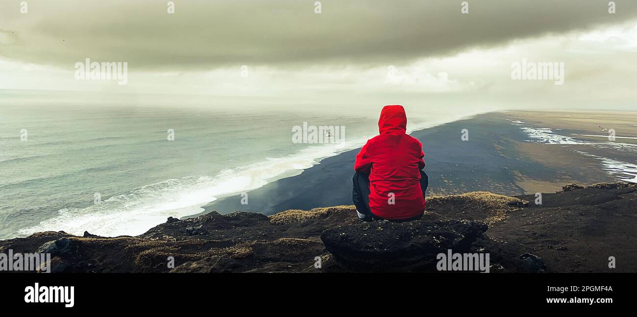 Man sit on rock thoughtful look at atlantic ocean waves. Famous iconic ...