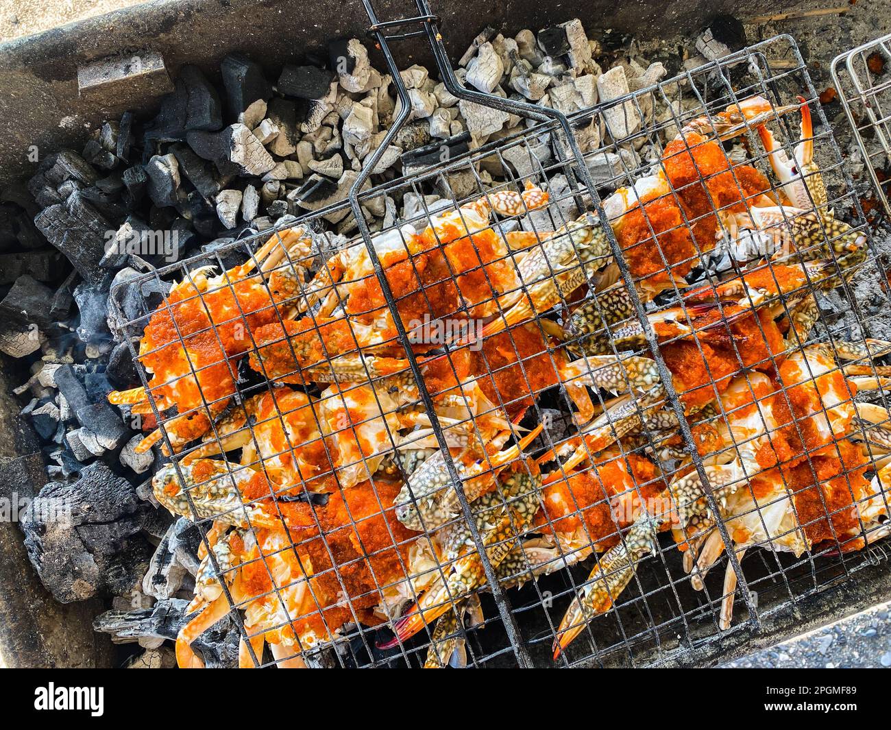 Top view fresh crabs cooked on bbq grill using coil. Gurman dish ...