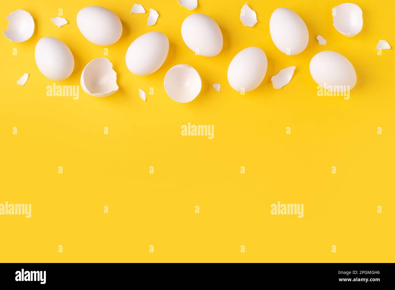 White Easter eggs and shells on a bright yellow background Stock Photo ...