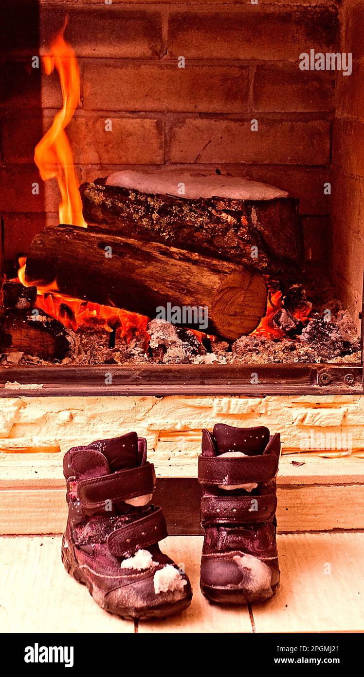 boots near the burning fire Stock Photo - Alamy