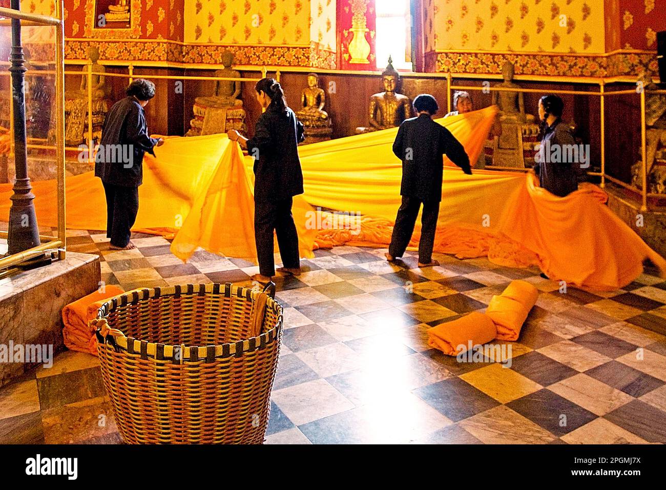 to fold an orange cloth in a Buddhist temple Stock Photo - Alamy