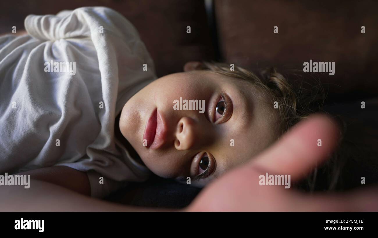 One tired little boy waking up from nap. Sleeping child wakes up from ...