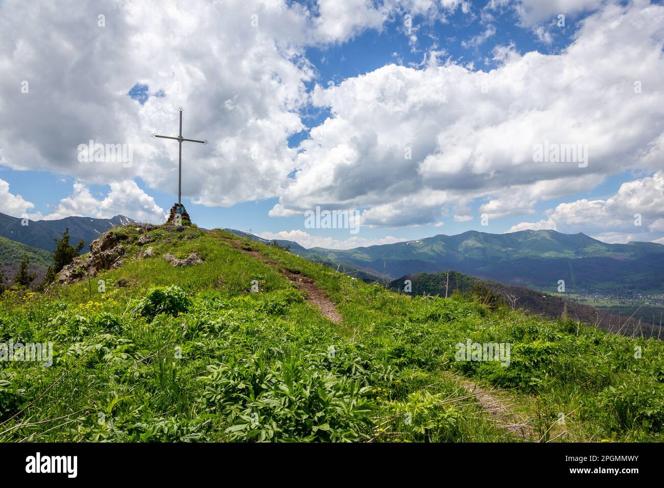 Roadside religious cross with orthodox Saint icon on a hill on M-20 ...