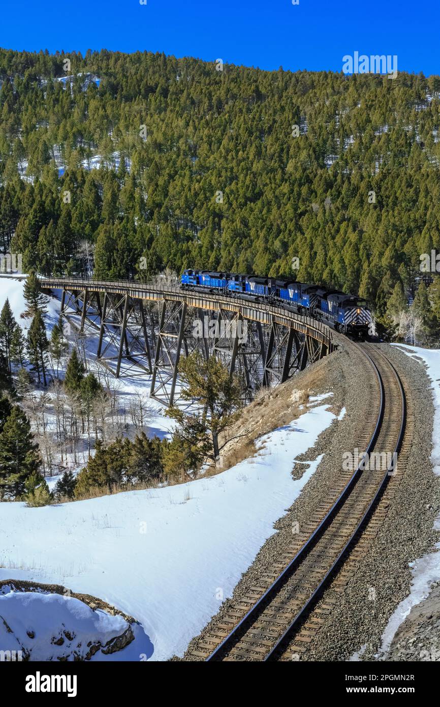 helper engines traveling over the railroad trestle below mullan pass ...