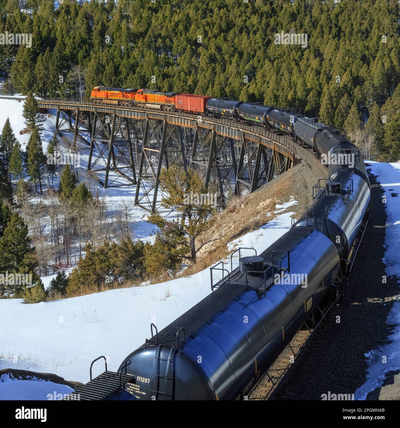 train hauling oil cars over the trestle below mullan pass near austin ...
