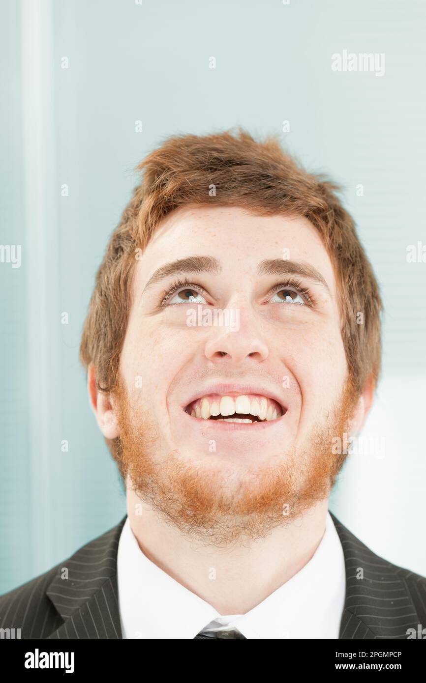 Close-up portrait of young man with short red hair and beard. Joyful ...