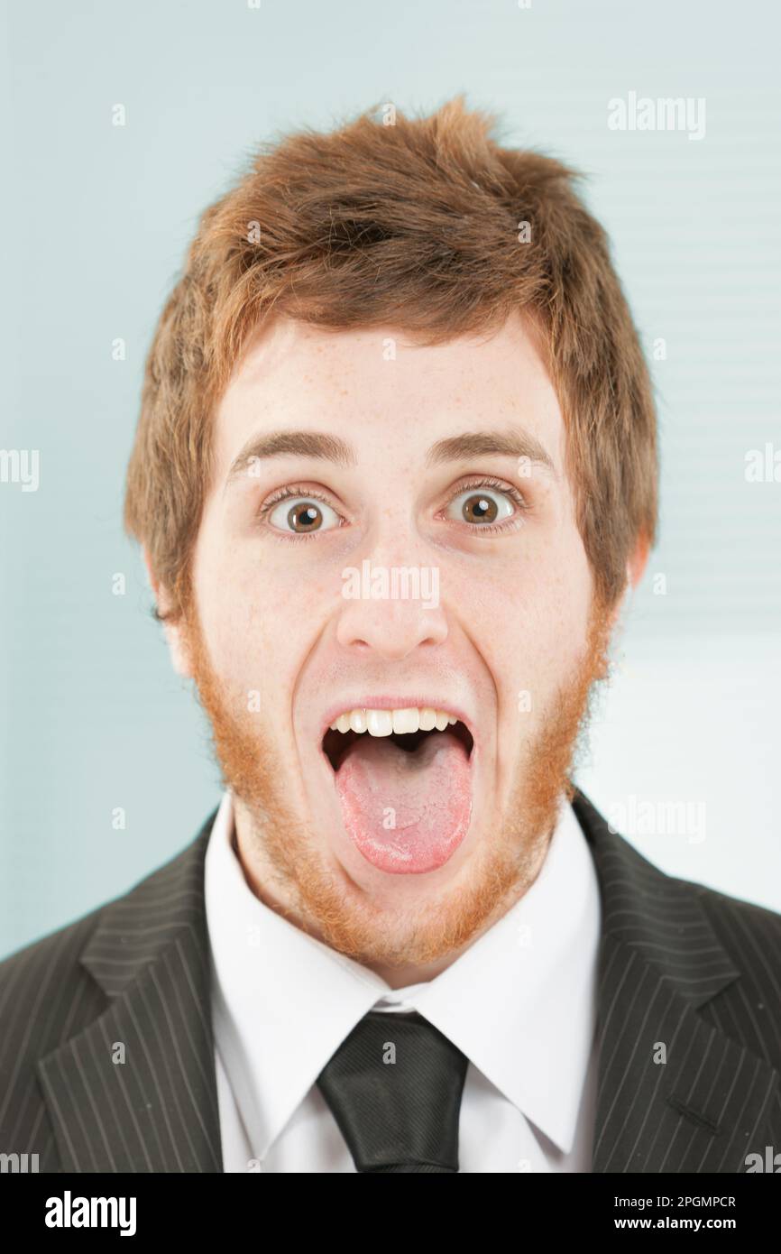 Close-up frontal portrait of young man with short red hair and beard ...