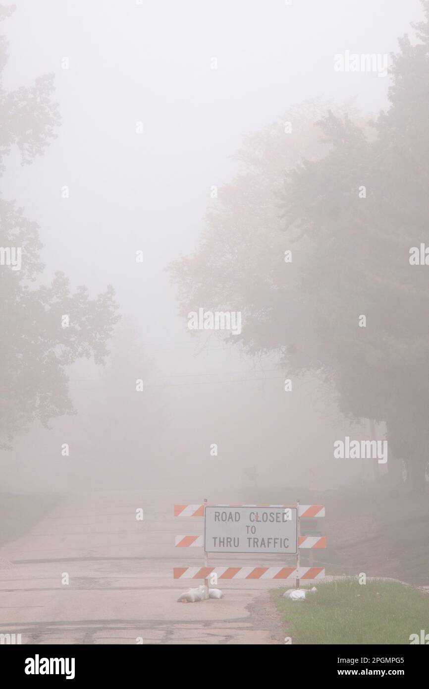 Road Construction Barricade in Fog with Closed to Thru Traffic Sign ...