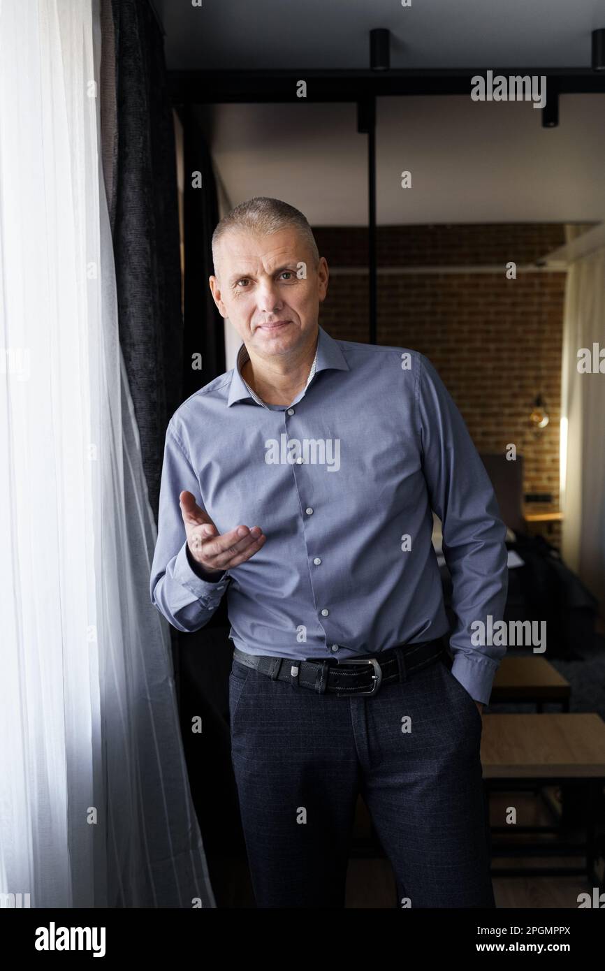 Close-up portrait of a middle-aged business man who shows a suggestion ...