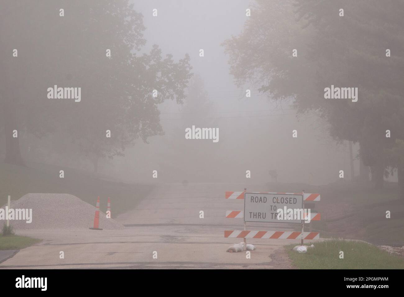 Road Construction Barricade in Fog with Closed to Thru Traffic Sign ...