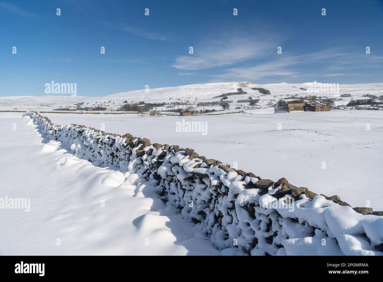 Snowdrifts behind drystone walls after a snowstorm in Wensleydale ...