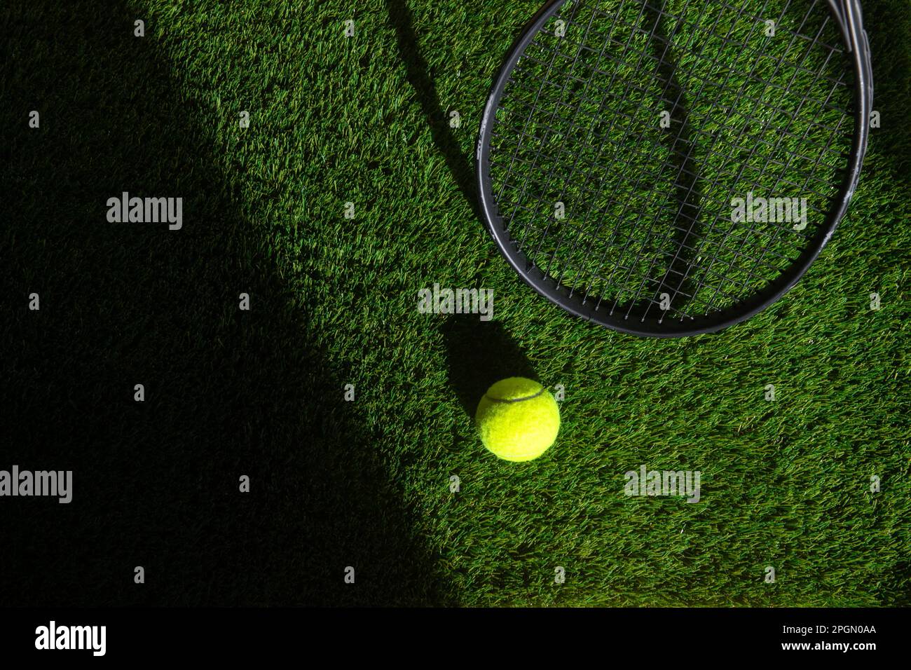 Top view of tennis rackets and ball of green grass. Horizontal sport ...