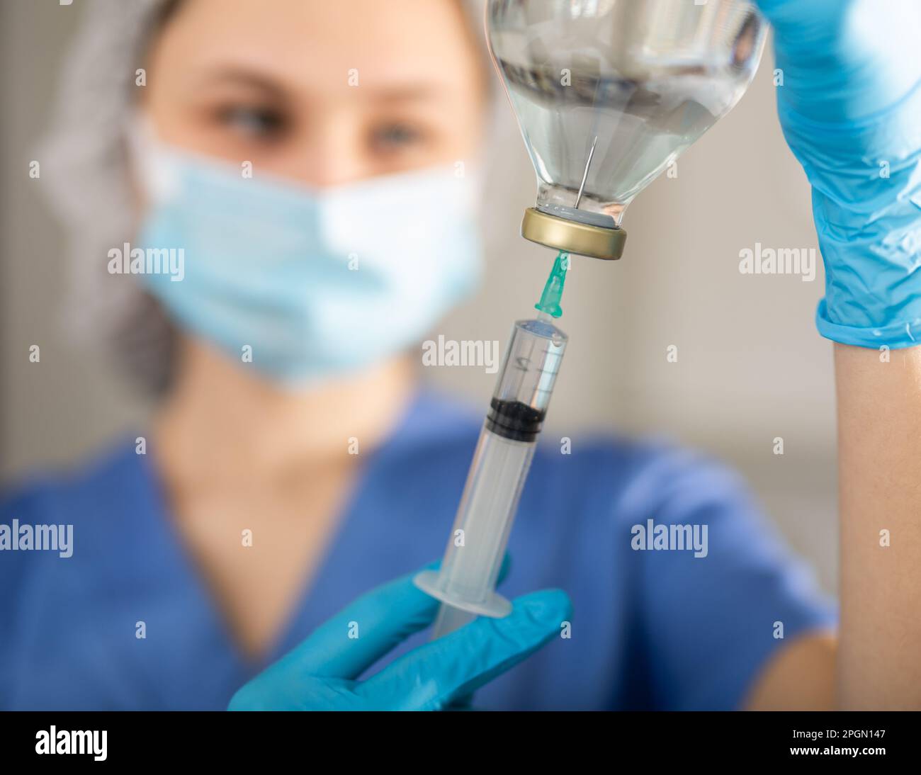 Young female nurse in the treatment room at the clinic prepares a ...