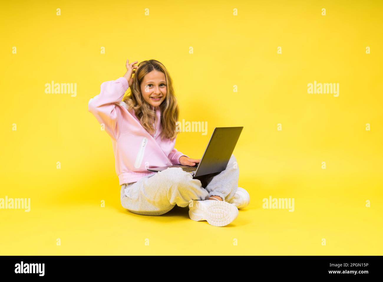 Positive kid sit with a laptop read homework wear casual style cloth ...