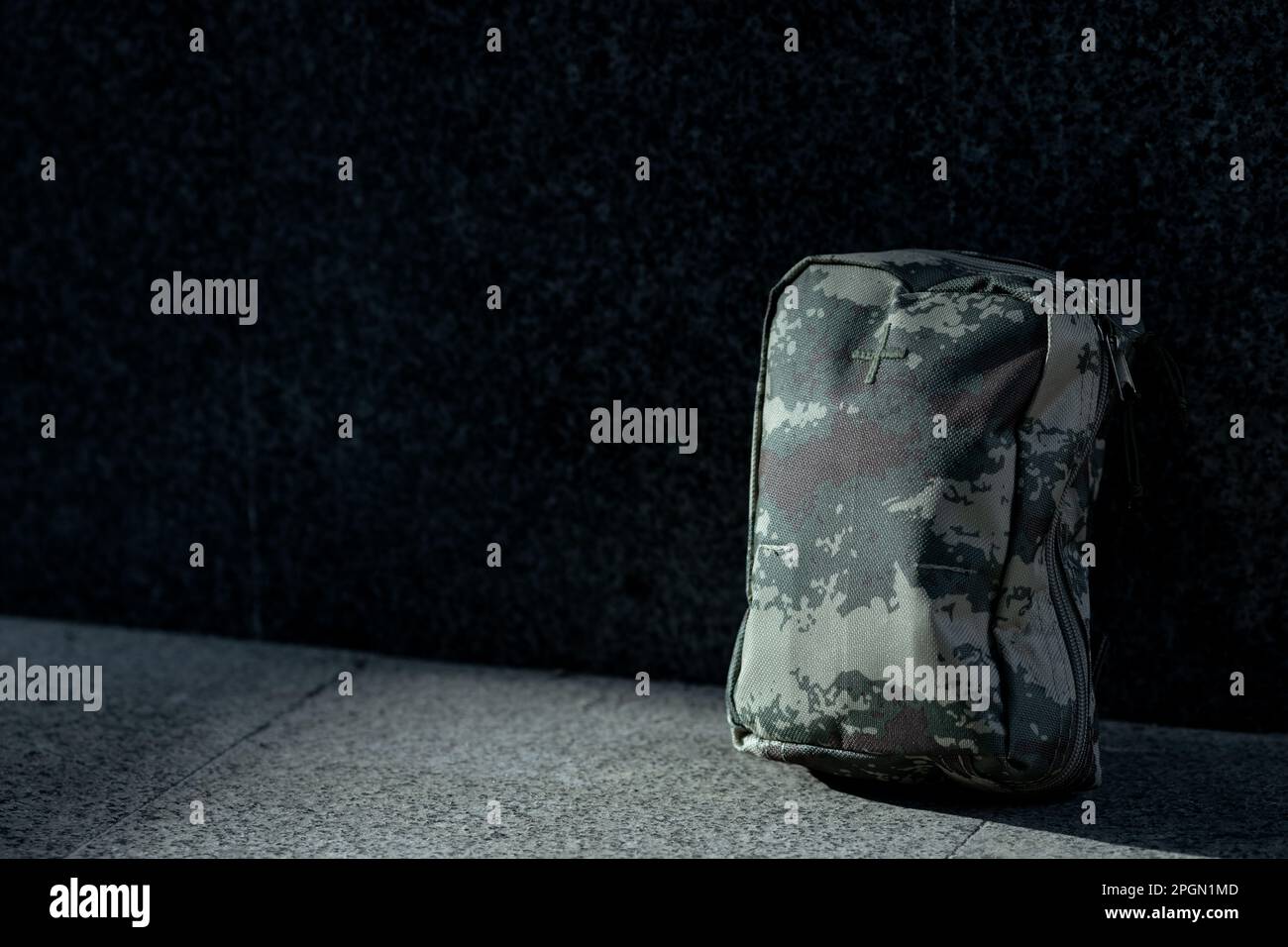 Military first aid kit closeup on marble background with space for text ...