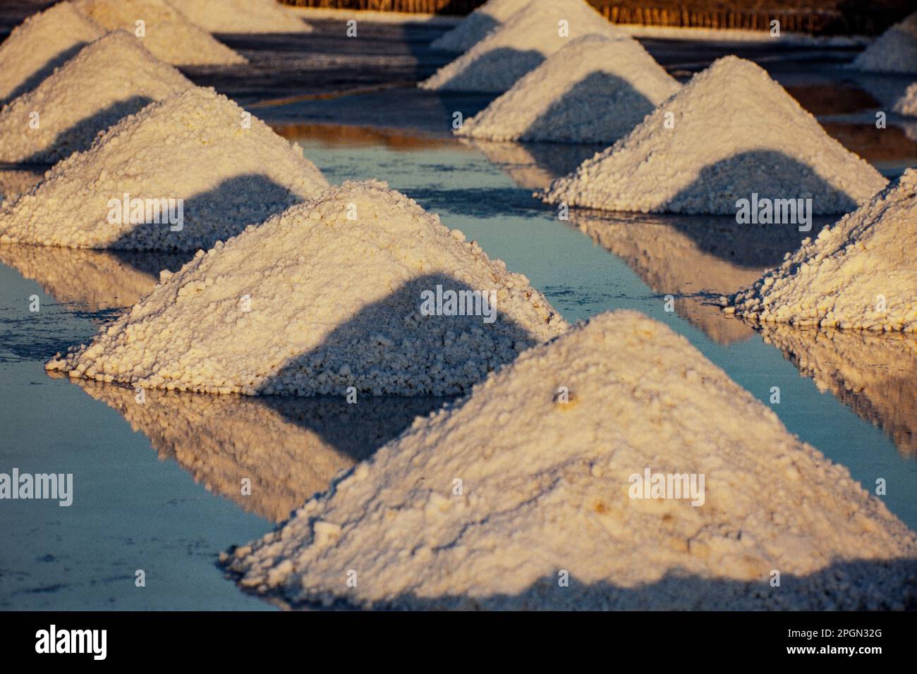Salt mounds, sea salt harvesting, produced by the evaporation of ...